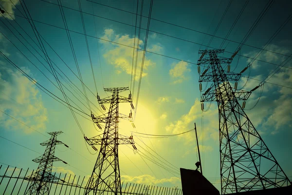The power transmission towers of sunset sky background — Stock Photo ...