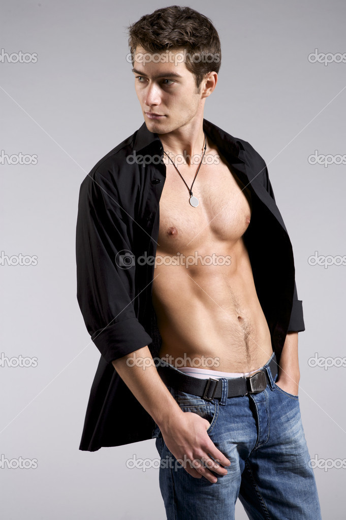 Portrait of muscle man posing on a grey background Stock Photo by ...