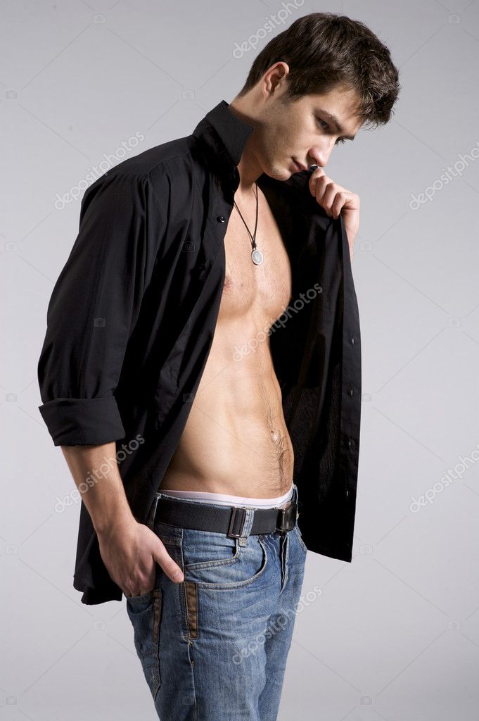 Portrait of muscle man posing on a grey background Stock Photo by ...