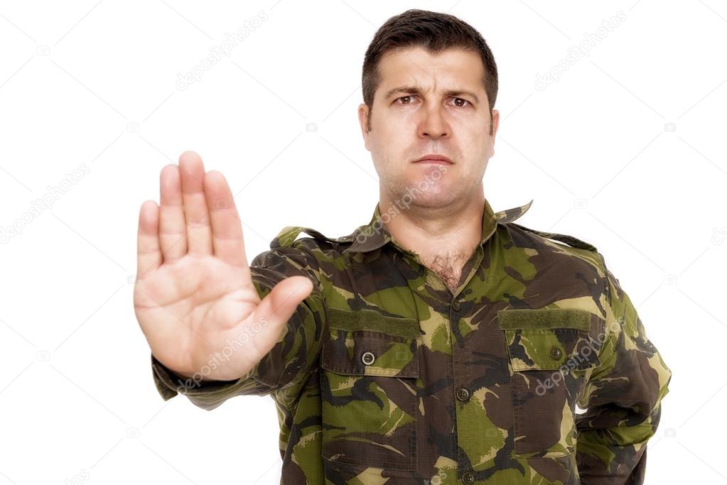 Serious army soldier making stop sign isolated on white — Stock Photo ...