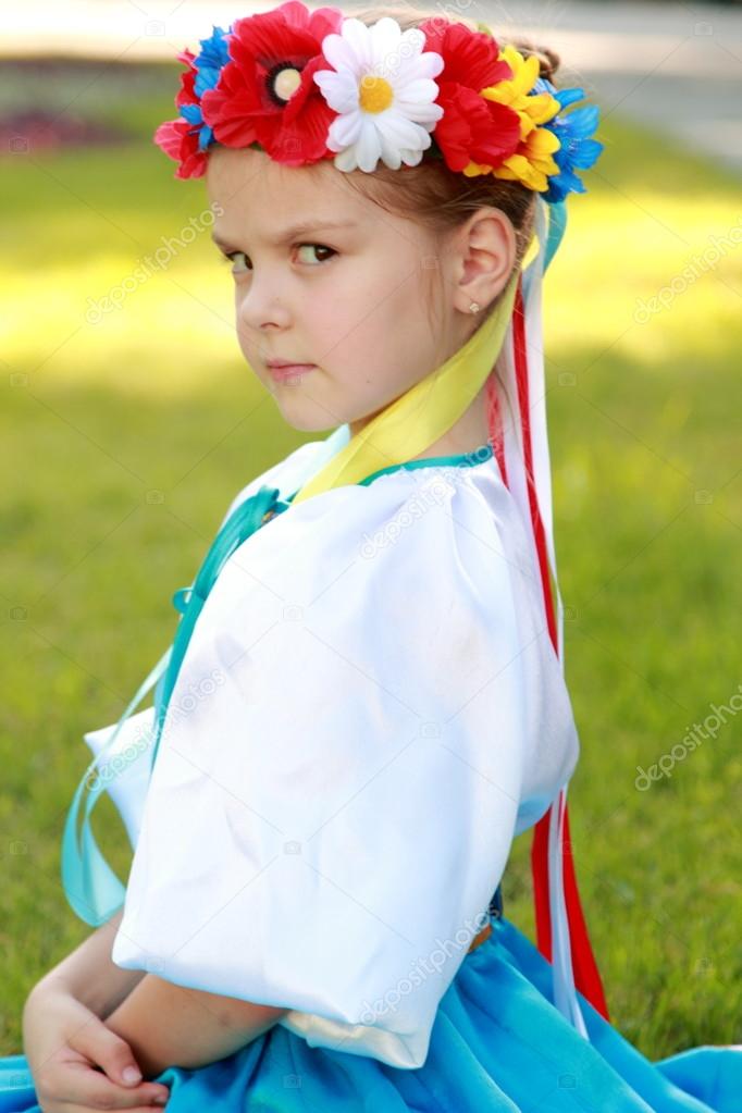 Cute little girl with a charming smile in a beautiful national costume ...