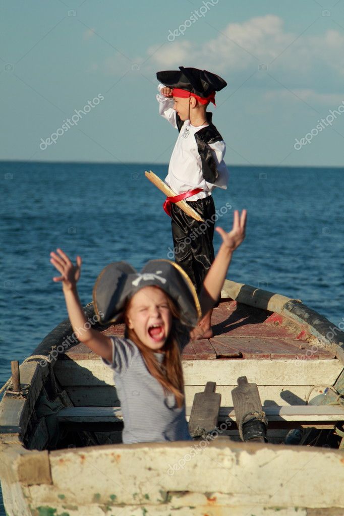 Caucasian joyful little children playing pirates on the sea — Stock ...