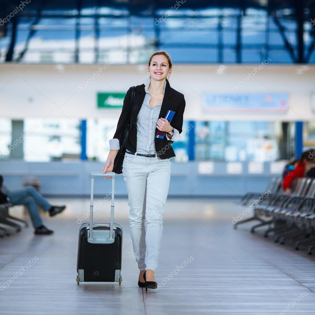 Pretty young female passenger at the airport — Stock Photo © lightpoet ...