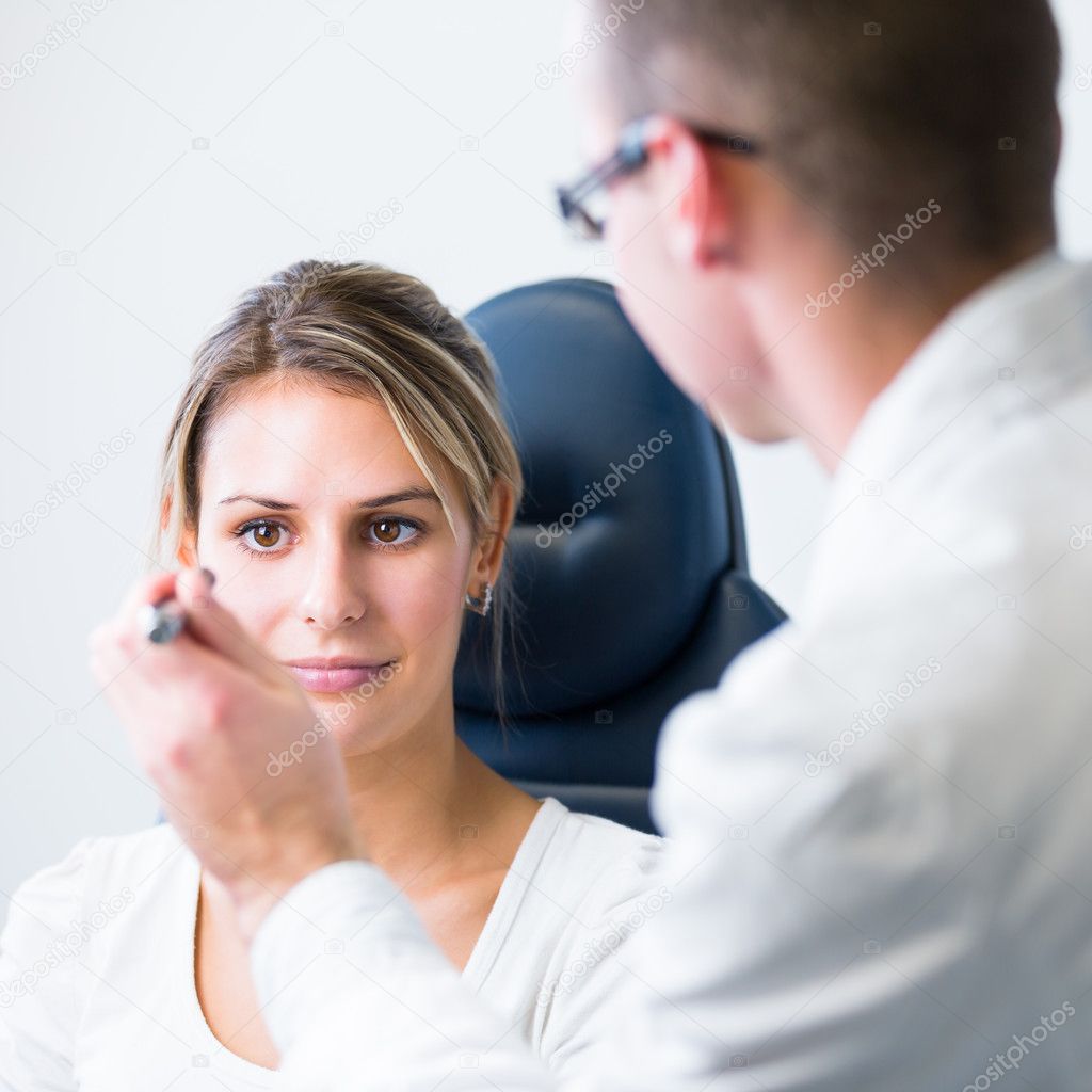 Optometry concept - pretty young woman having her eyes examined — Stock ...
