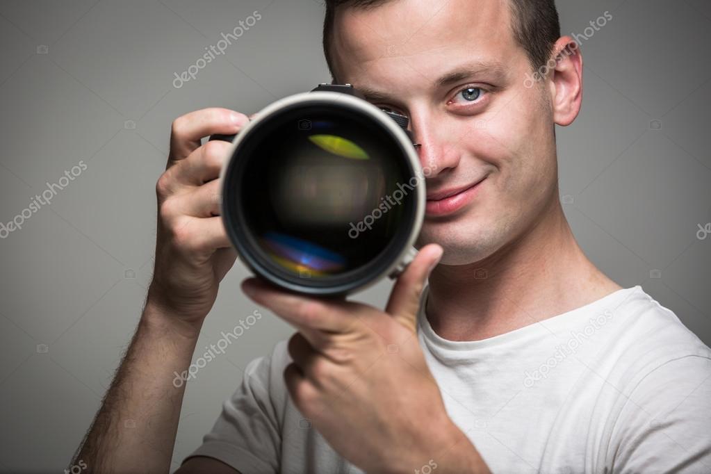 Young pro photographer with digital camera — Stock Photo © lightpoet ...