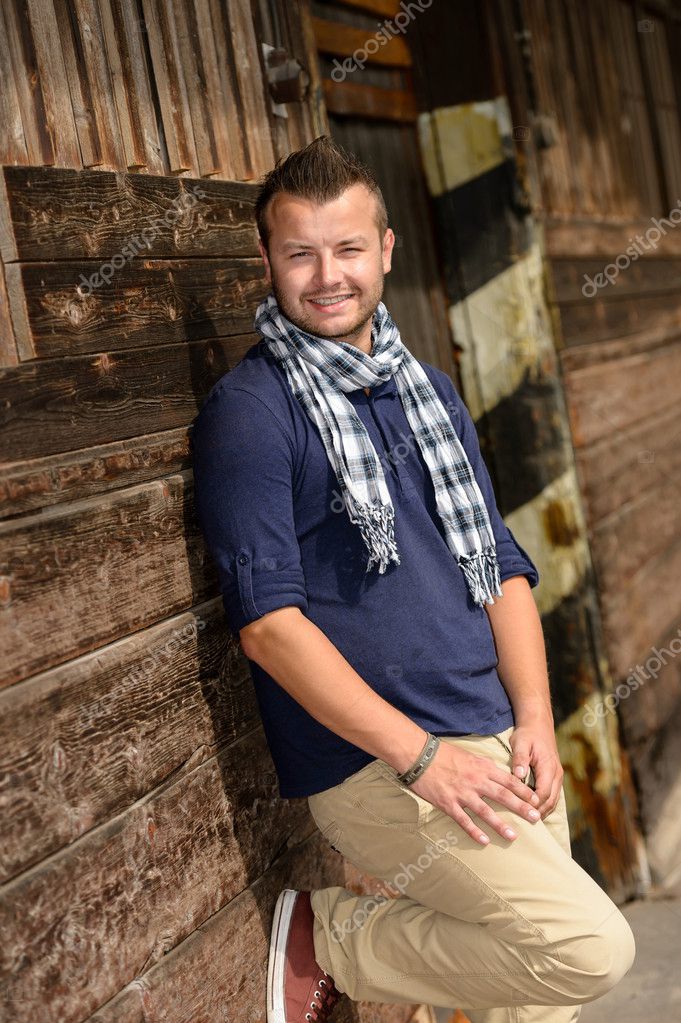 Man posing leaning against wooden wall fashion Stock Photo by ...