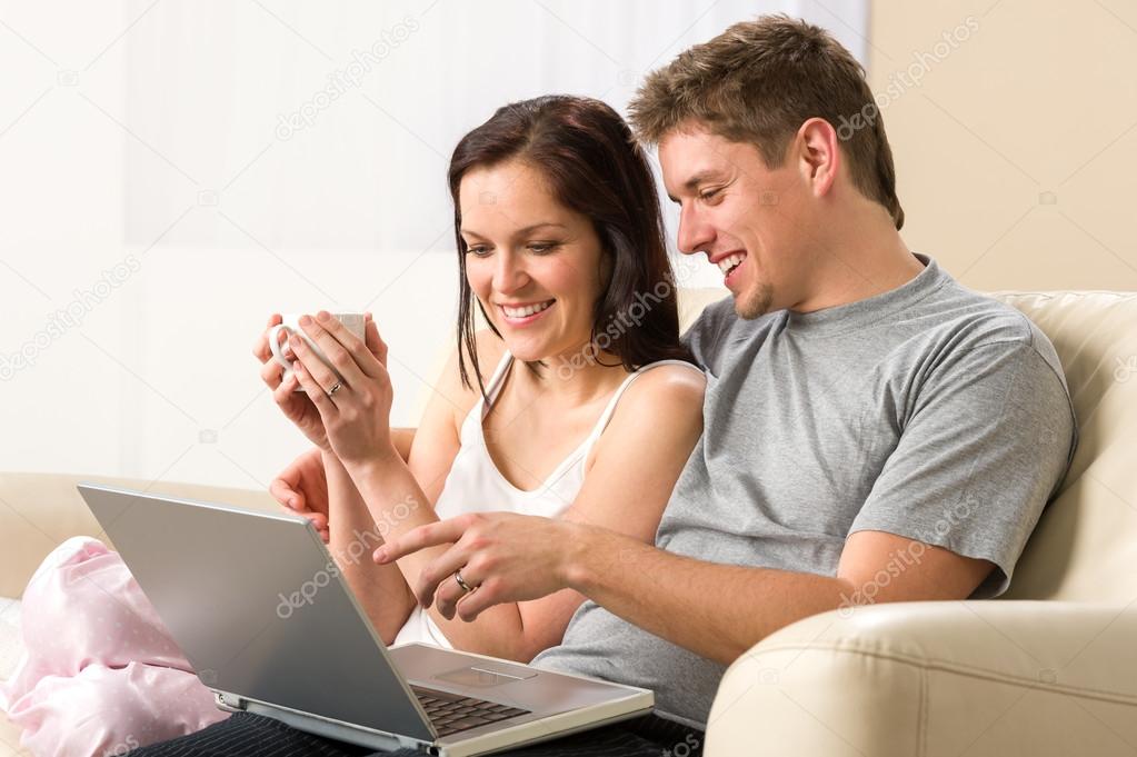 Cheerful couple using laptop together — Stock Photo © CandyBoxImages ...