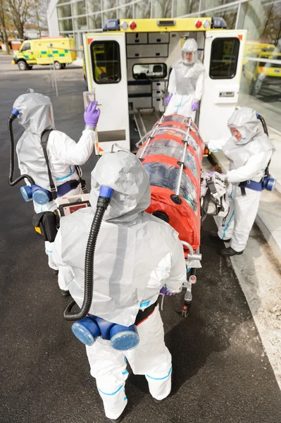 Biohazard medical team walking to building — Stock Photo ...