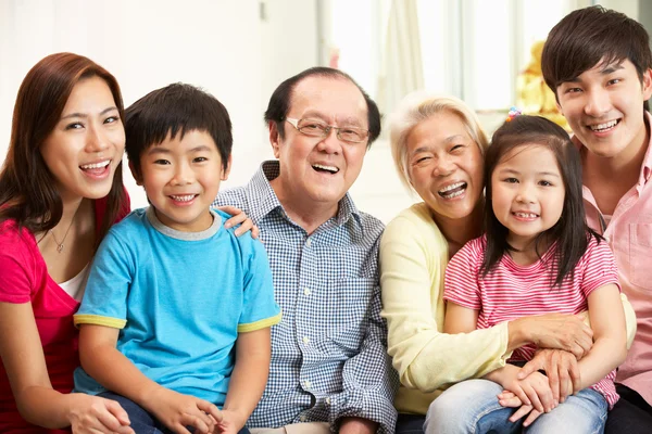 Portrait Of Multi-Generation Chinese Family Relaxing At Home Tog ...