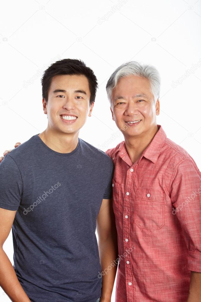 Studio Portrait Of Chinese Father With Adult Son Stock Photo by ...