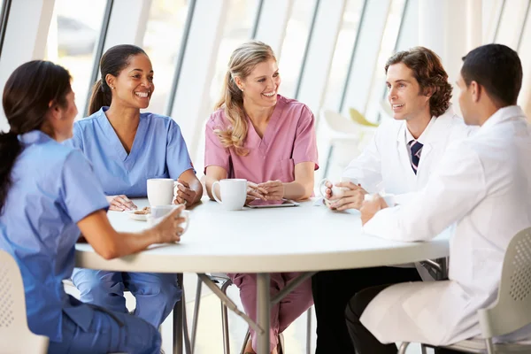 Group Of Nurses Chatting In Modern Hospital Canteen Stock Photo by ...