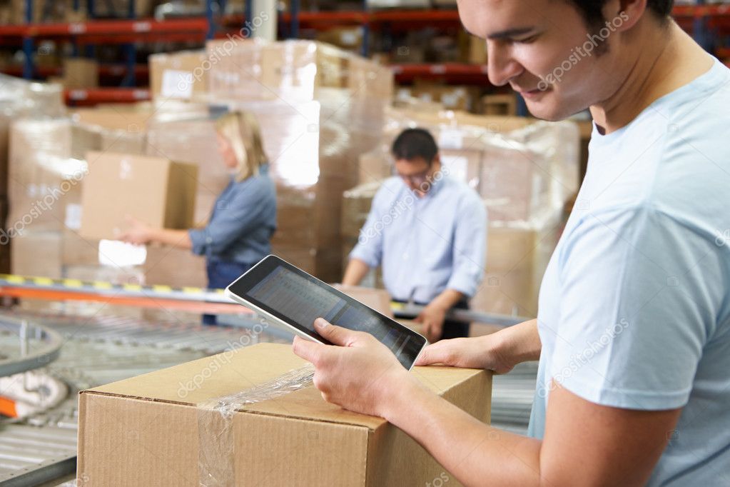 Worker Using Tablet Computer In Distribution Warehouse — Stock Photo ...