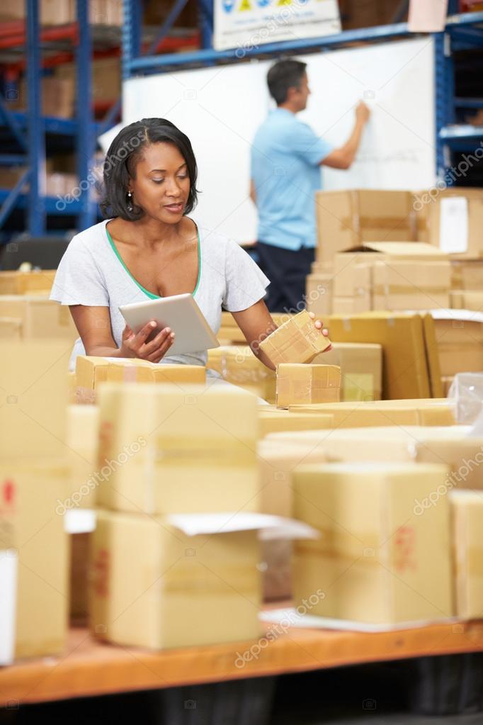 Workers In Warehouse Preparing Goods For Dispatch Stock Photo by ...