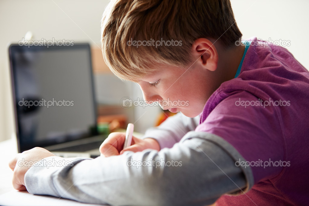 Boy Studying In Bedroom Using Laptop Stock Photo by ©monkeybusiness ...
