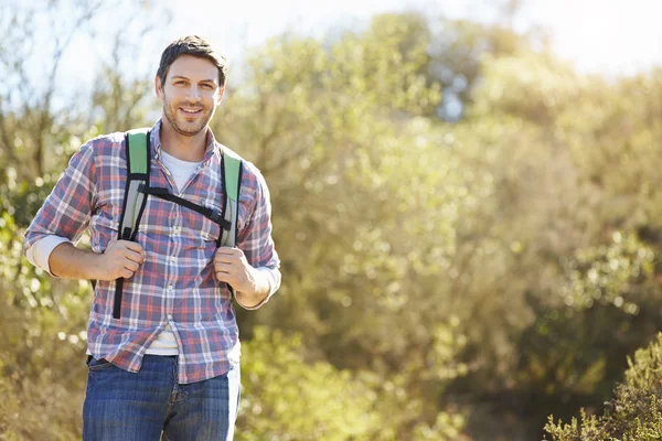 Portrait Of Man Hiking In Countryside Wearing Backpack - Stock Image ...