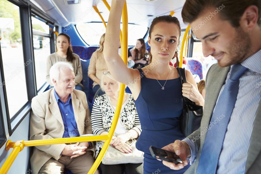 Passengers Standing On Busy Commuter Bus — Stock Photo © monkeybusiness ...