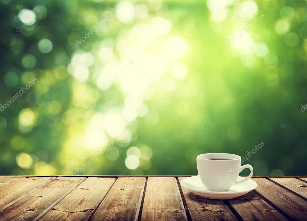 Cup coffee and sunny trees background Stock Photo by ©Iakov 50590001