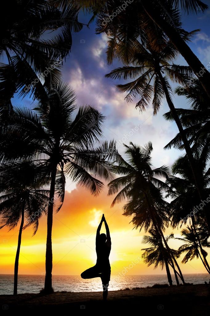 Yoga tree pose around palm trees Stock Photo by ©byheaven 16892759