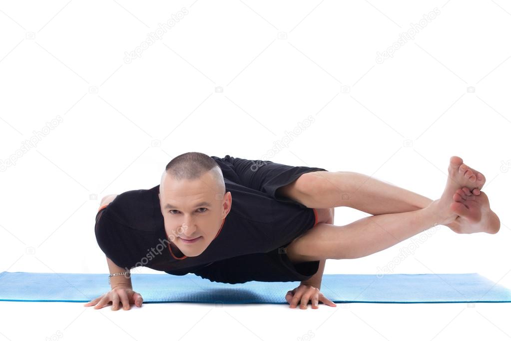 Smiling flexible man posing in difficult yoga pose — Stock Photo ...