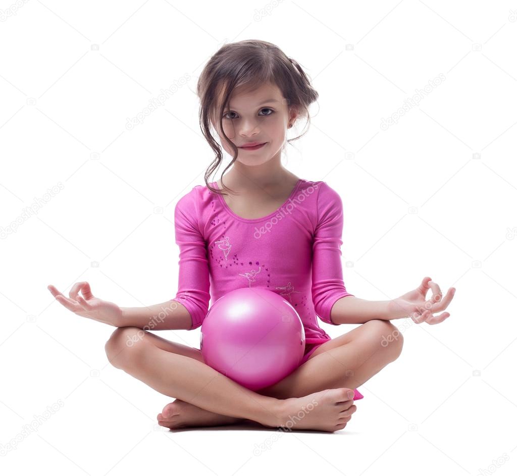 Smiling gymnast posing in lotus position with ball Stock Photo by ...