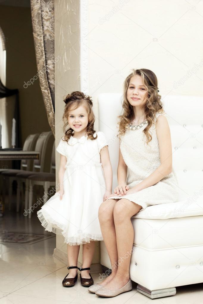 Two smiling cute girlfriends posing at camera — Stock Photo © Wisky #48221709