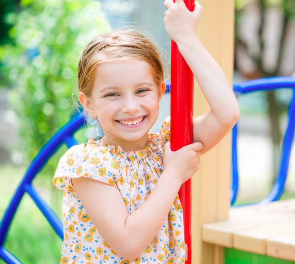 Cute little girl on playground — Stock Photo © tan4ikk #1127446