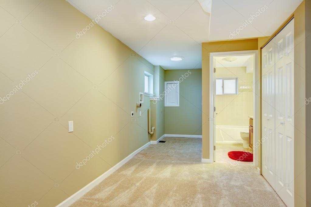 Basement hallway with laundry space and bathroom. Stock Photo by ...