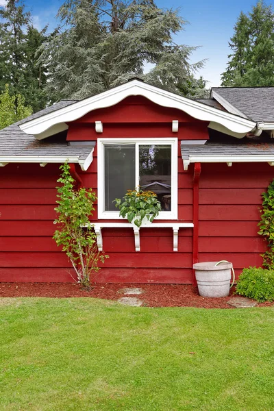 Bright red house with walkout deck and patio area Stock Photo by ...
