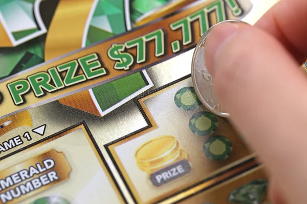 Macro woman scratching lottery ticket at prize area - Stock Image ...