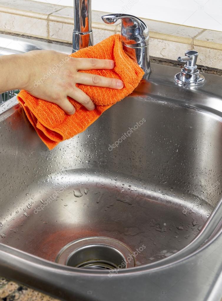 Female hand Drying Kitchen Sink Stock Photo by ©tab62 21298069