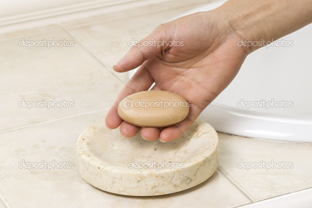 Female hand picking up bar of soap Stock Photo by ©tab62 29580617