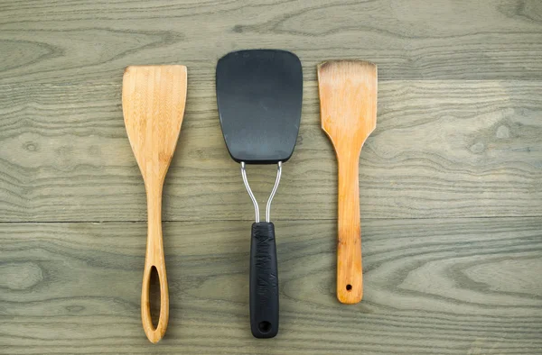 kitchen spatulas on aged wood - Stock Image - Everypixel