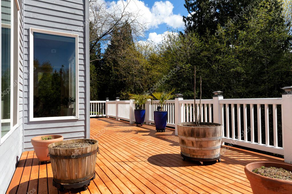 Home outdoor cedar wood backyard deck just freshly stained during early ...