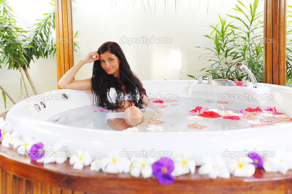 Pretty woman relaxing in jacuzzi — Stock Photo © yellow2j #33273175