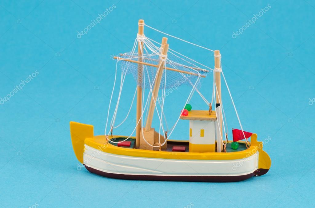 Wooden handmade boat ship model on blue background Stock Photo by ...