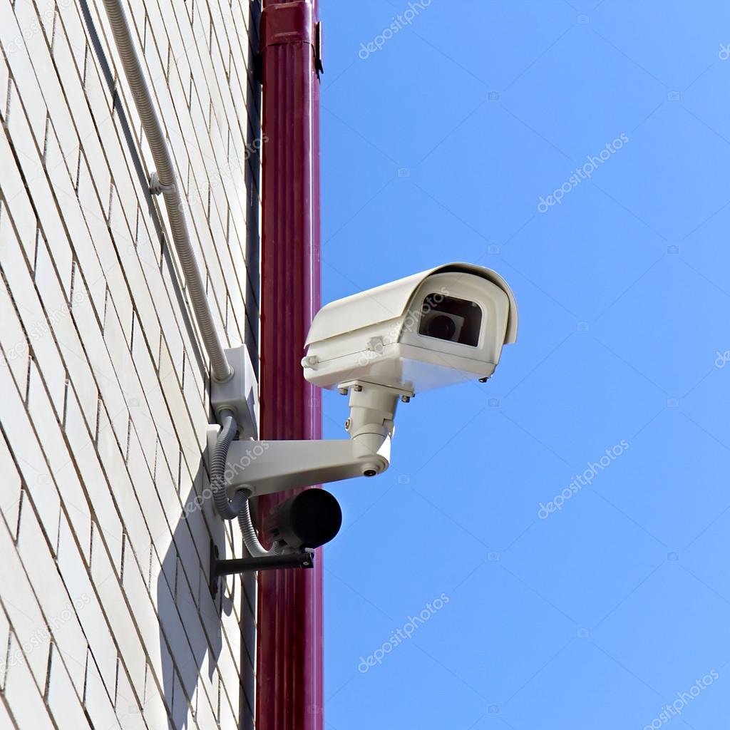 Video surveillance camera on a wall of the building Stock Photo by ...