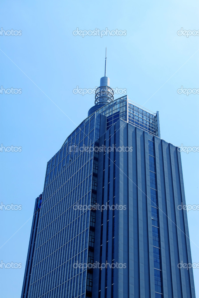 Tall building under blue sky — Stock Photo © lnzyx #50689687
