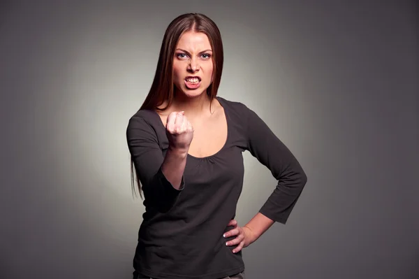 Angry woman threatening the fist - Stock Image - Everypixel