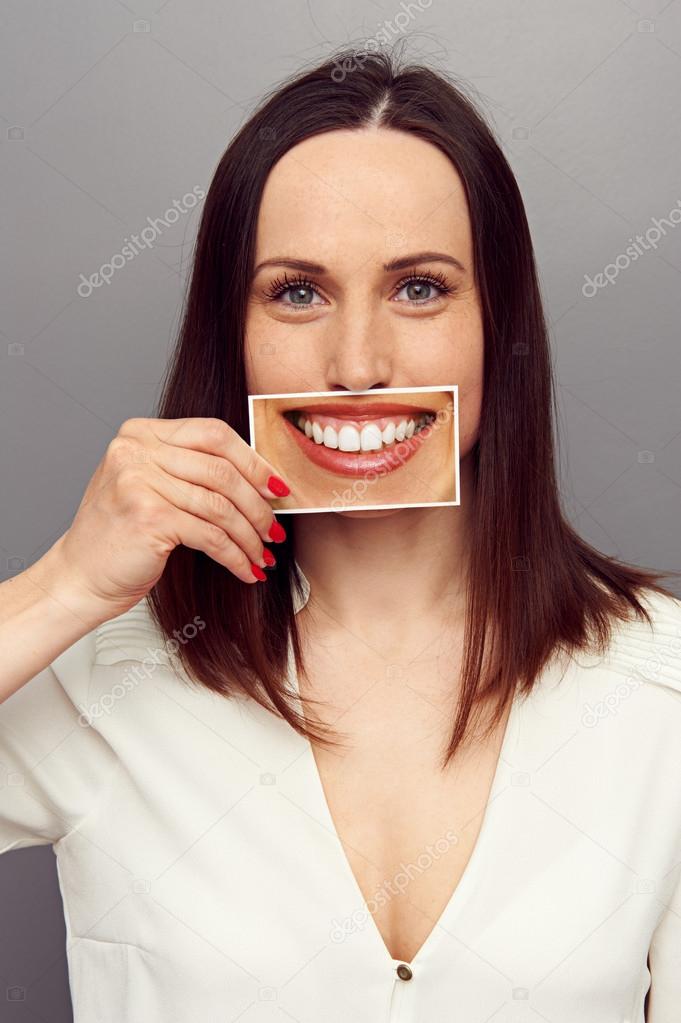 Woman hiding her emotions behind smile — Stock Photo © konstantynov ...