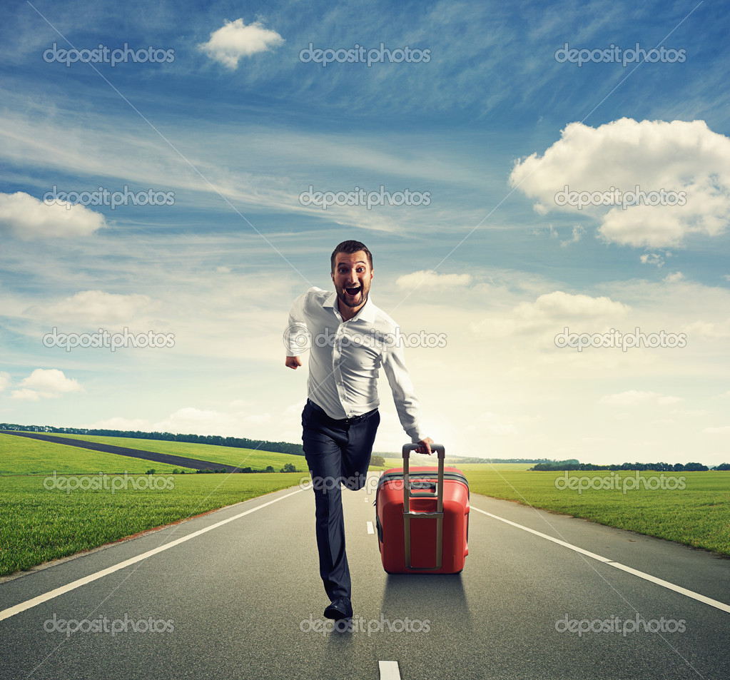Man running with suitcase on the road — Stock Photo © konstantynov ...