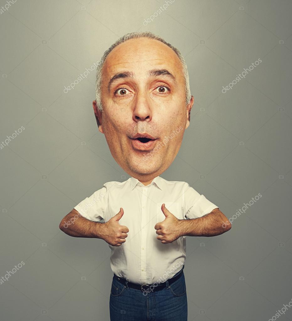 Senior man with big head showing thumbs up — Stock Photo © konstantynov ...