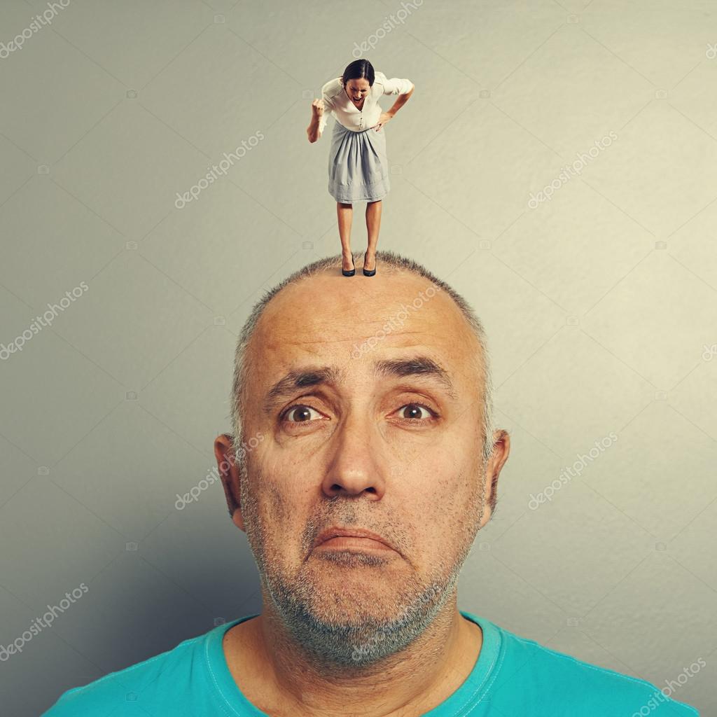 Sad man with small angry businesswoman Stock Photo by ©konstantynov ...