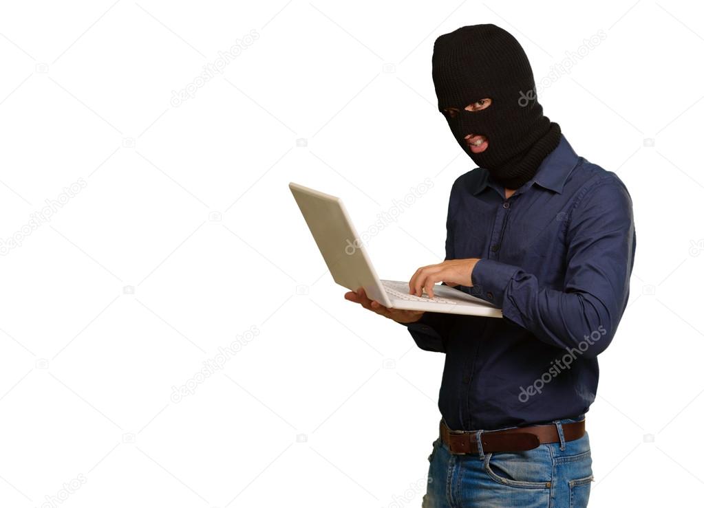 Young male thief holding laptop Stock Photo by ©Krakenimages.com 12666288