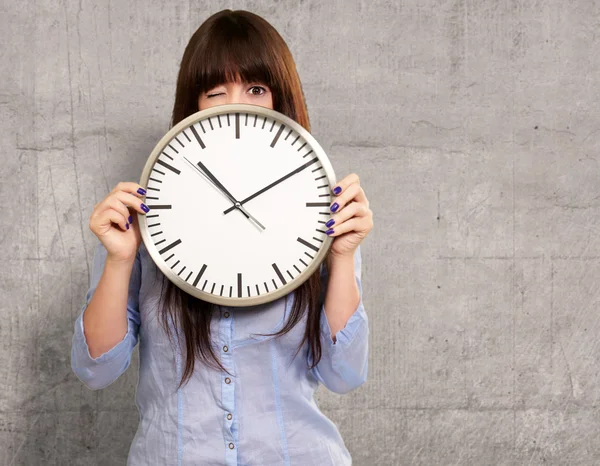 Woman Holding Clock Winking - Stock Image - Everypixel