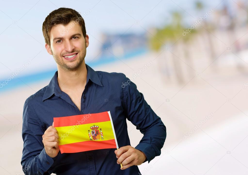 Young Man Holding Spain Flag — Stock Photo © coolfonk #18777923