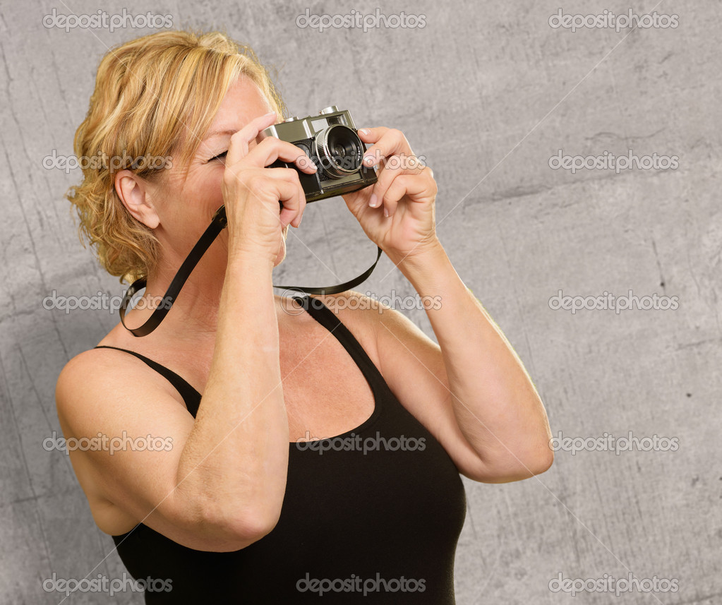 Mature Woman Holding Camera — Stock Photo © Krakenimages.com #18794531