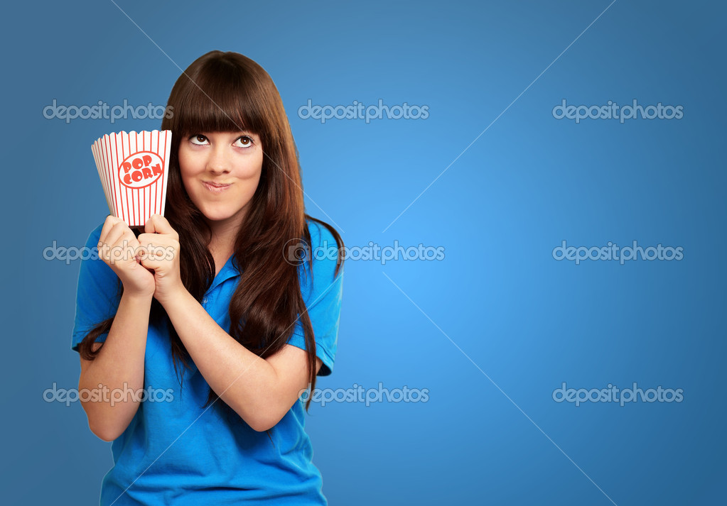 Girl holding empty popcorn packet Stock Photo by ©Krakenimages.com 18815873