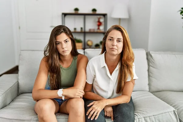 Mother Daughter Together Sitting Sofa Home Pointing Looking Sad Upset