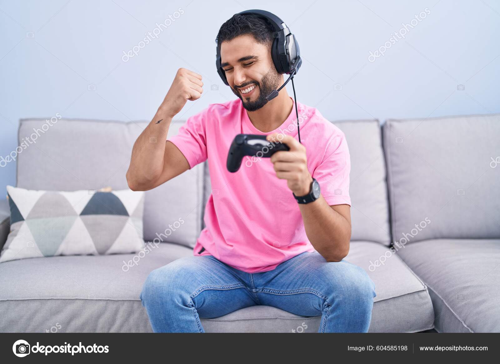 Hispanic Young Man Playing Video Game Holding Controller Sitting Sofa ...