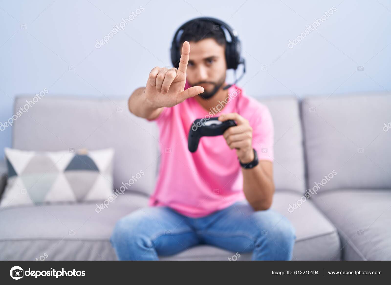 Hispanic Young Man Playing Video Game Holding Controller Sitting Sofa ...